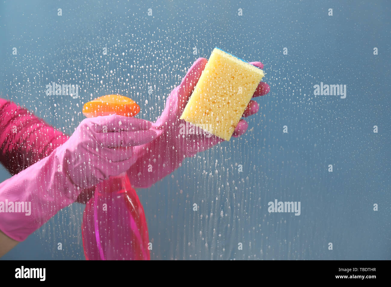 Woman washing window with detergent Stock Photo - Alamy