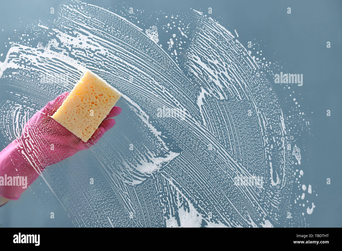 Woman washing window with detergent Stock Photo - Alamy
