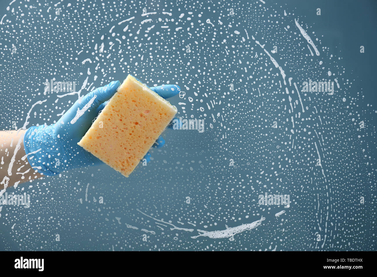 Woman washing window with detergent Stock Photo - Alamy
