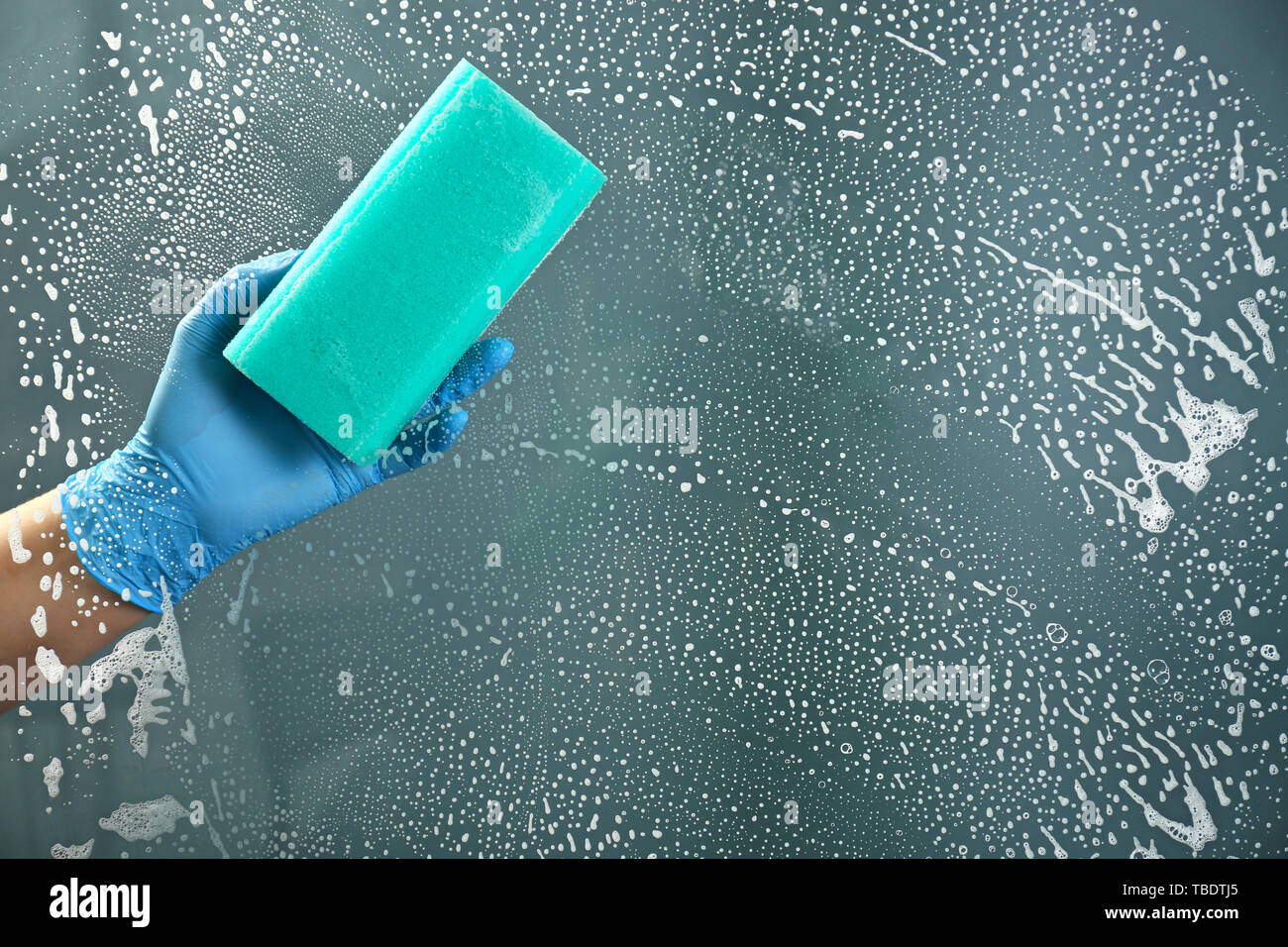 Woman washing window with detergent Stock Photo - Alamy