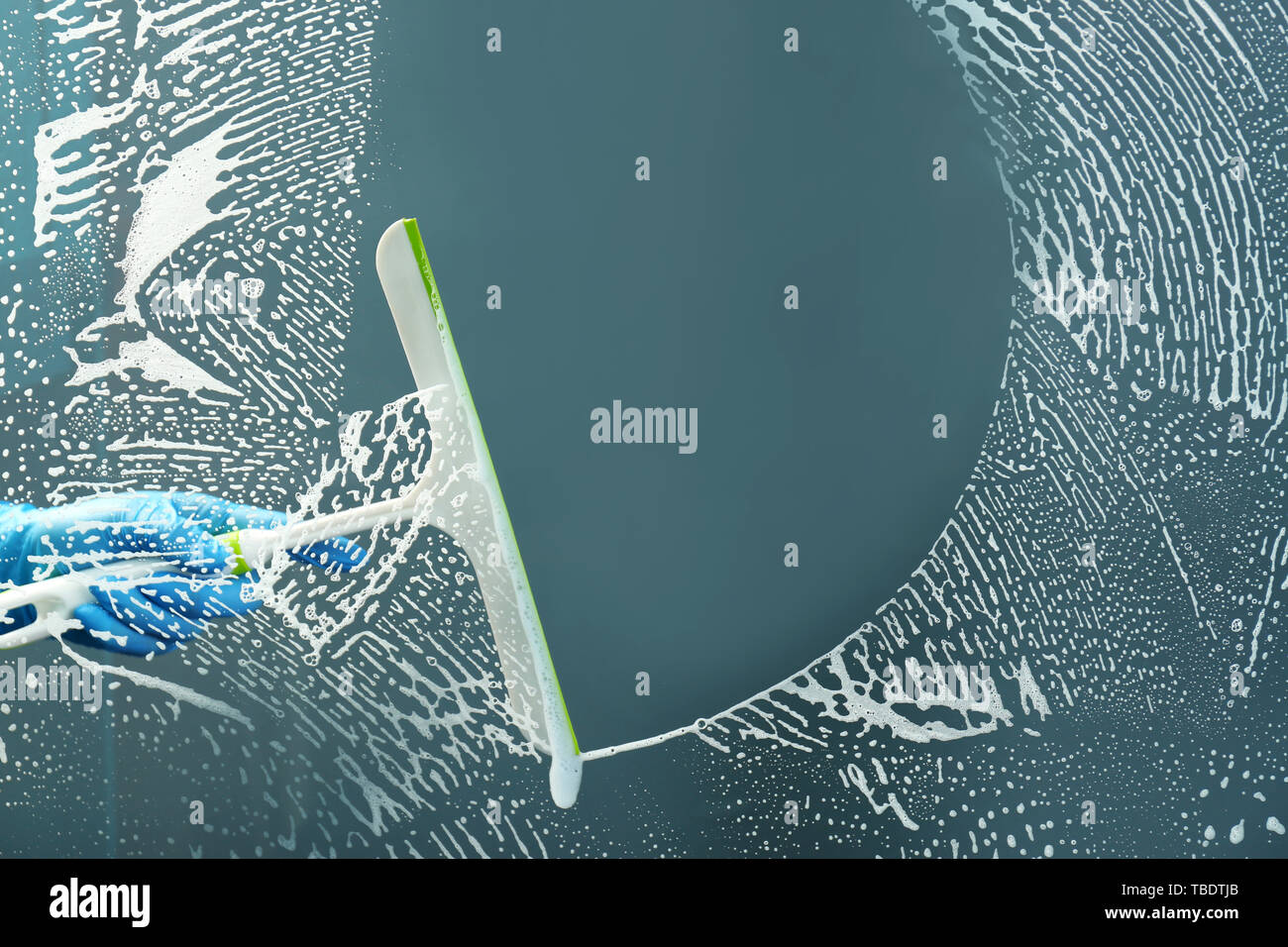 Woman washing window with detergent Stock Photo - Alamy
