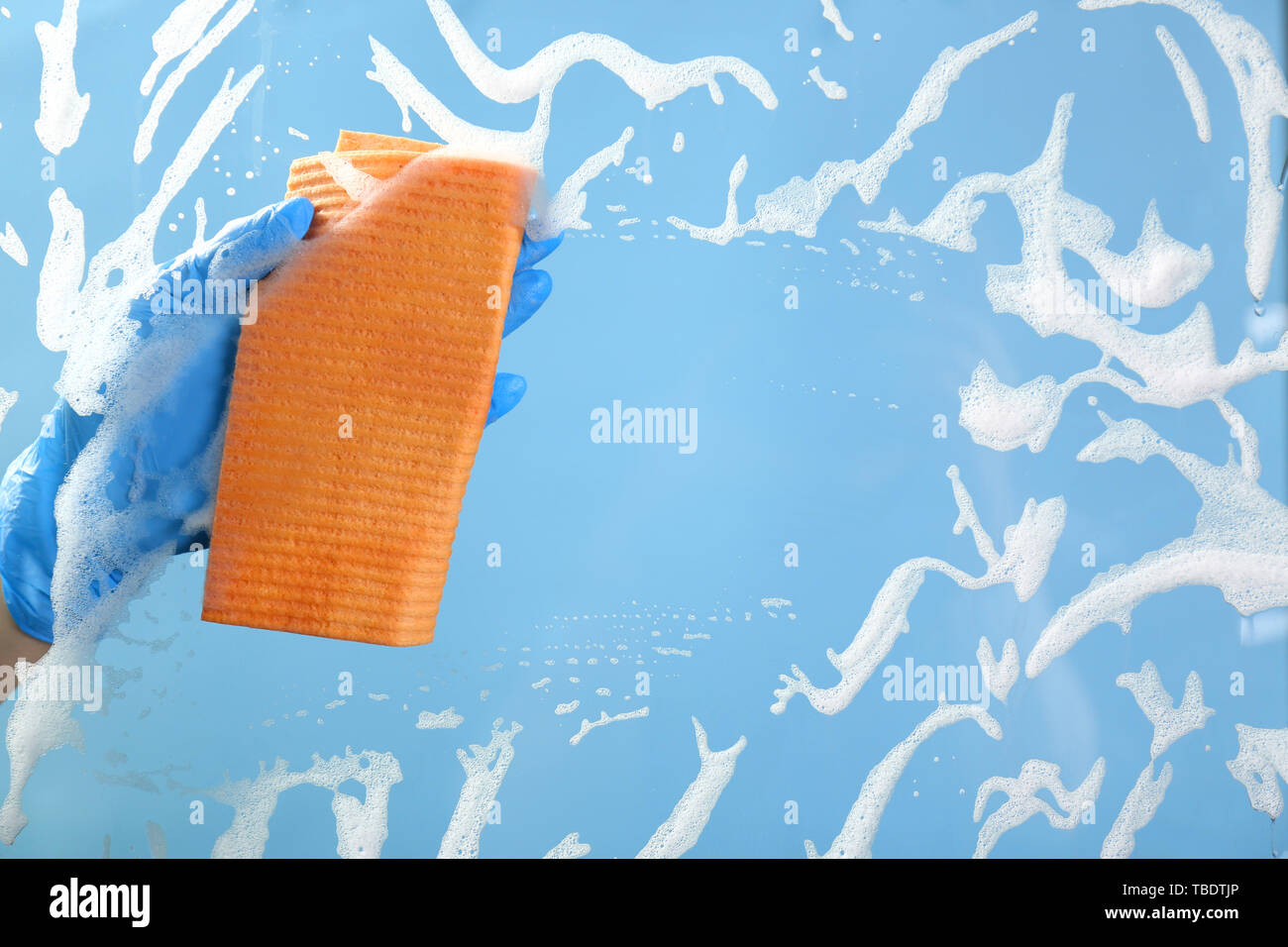 Woman washing window with detergent Stock Photo - Alamy