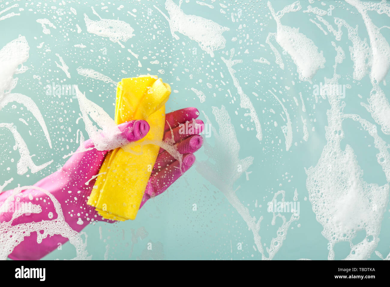 Woman washing window with detergent Stock Photo - Alamy