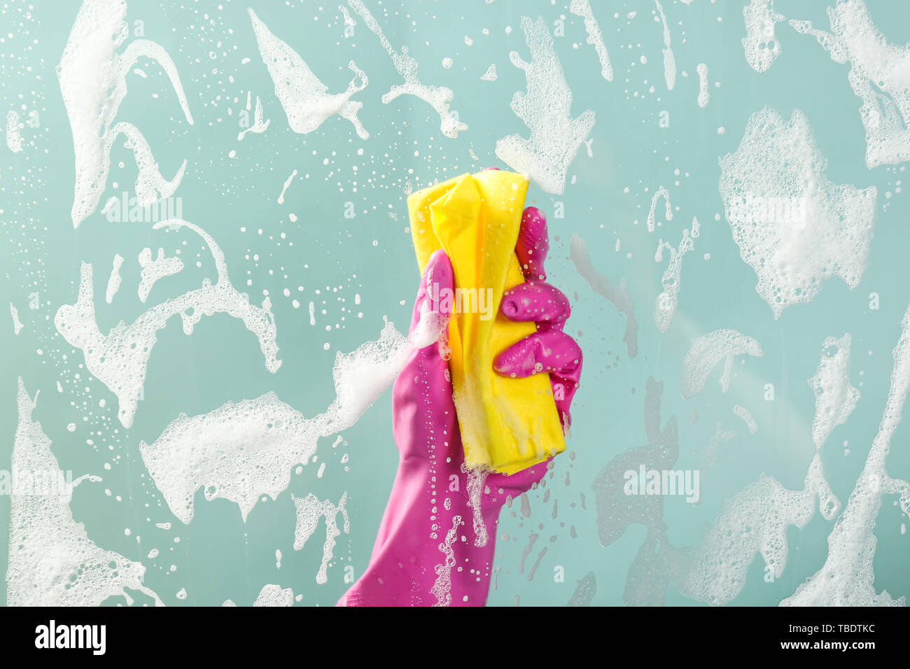Woman washing window with detergent Stock Photo - Alamy