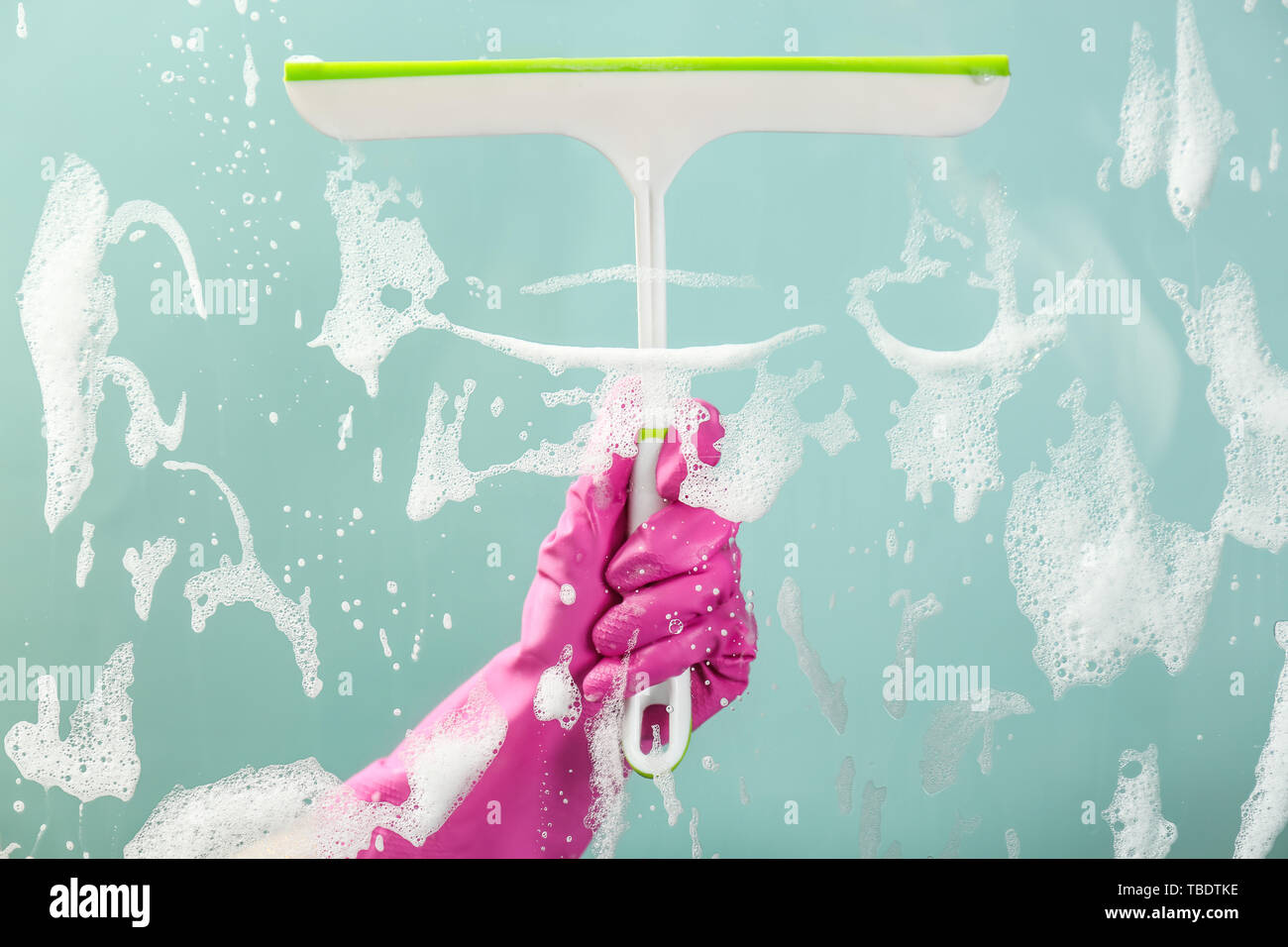 Woman washing window with detergent Stock Photo - Alamy