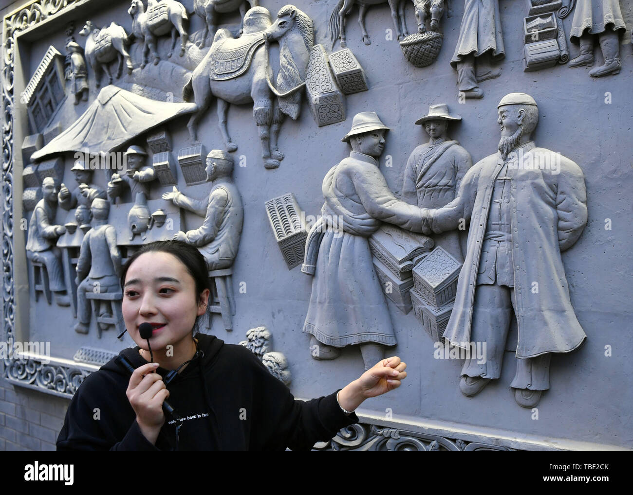Linxia, China's Gansu Province. 31st May, 2019. A tour guide introduces ...