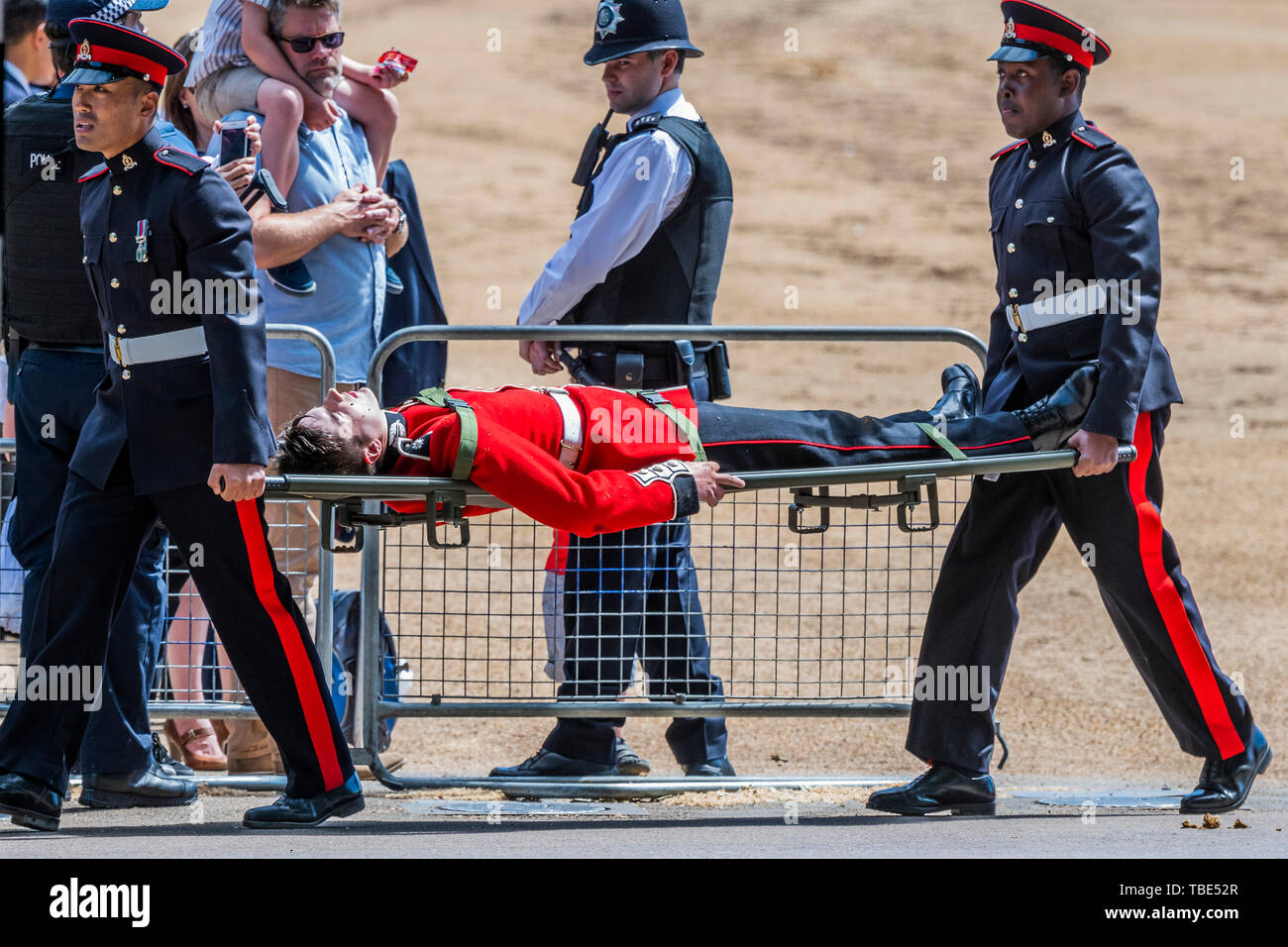 London, UK. 1st June 2019. Two guardsmen faint and are stretchered off ...