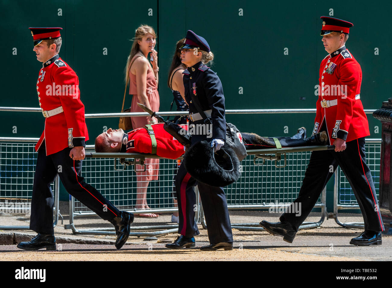 London, UK. 1st June 2019. Two guardsmen faint and are stretchered off ...