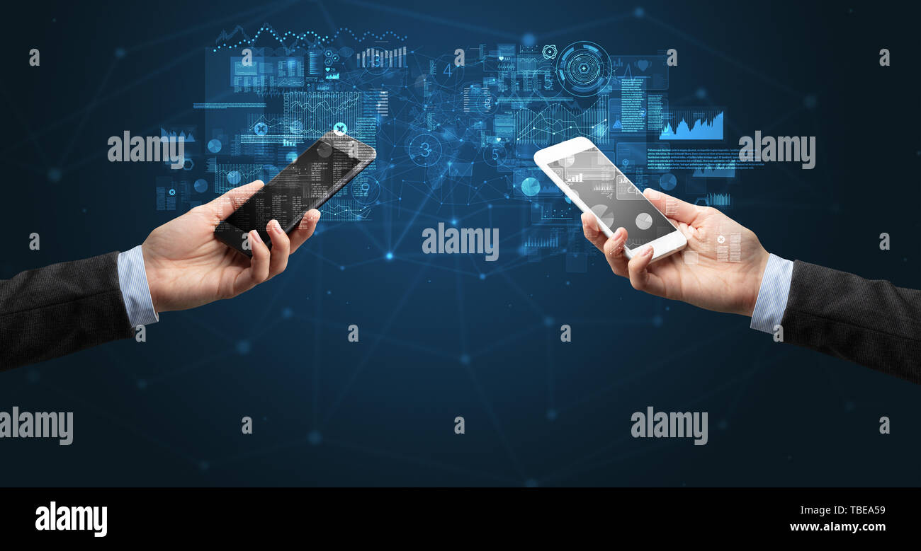 Close up of two hands holding smartphones to sync business data Stock ...