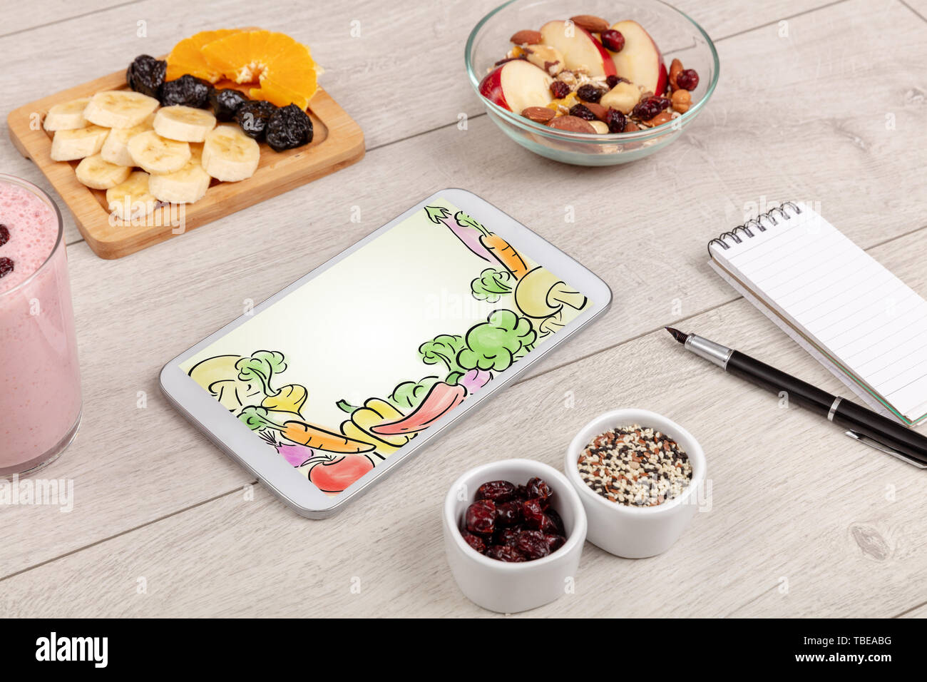 Healthy food composition with tablet Stock Photo - Alamy