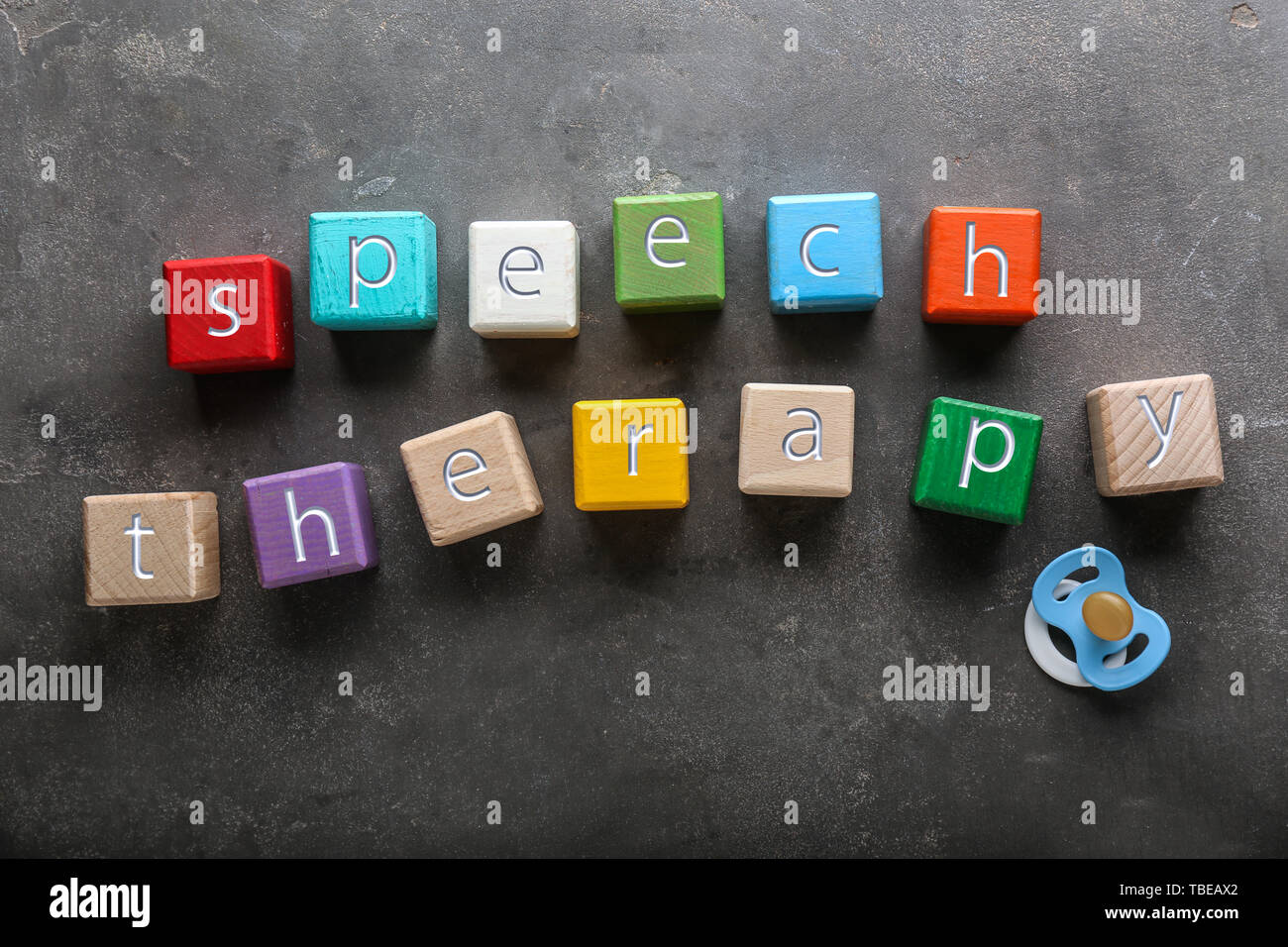 Cubes with text SPEECH THERAPY on grey background Stock Photo - Alamy
