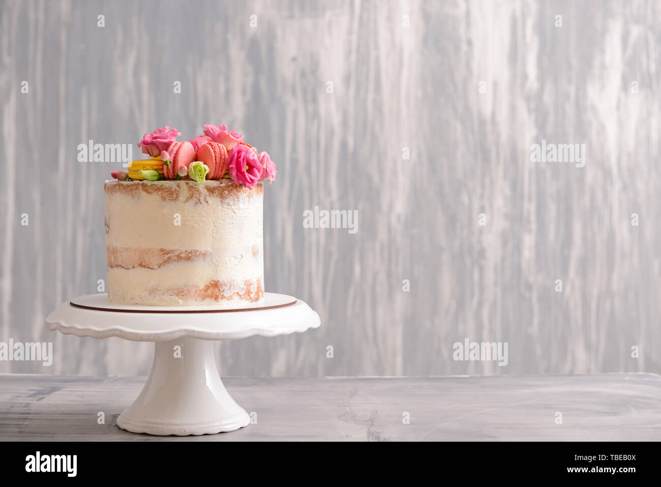 Sweet cake with floral decor on grey background Stock Photo - Alamy
