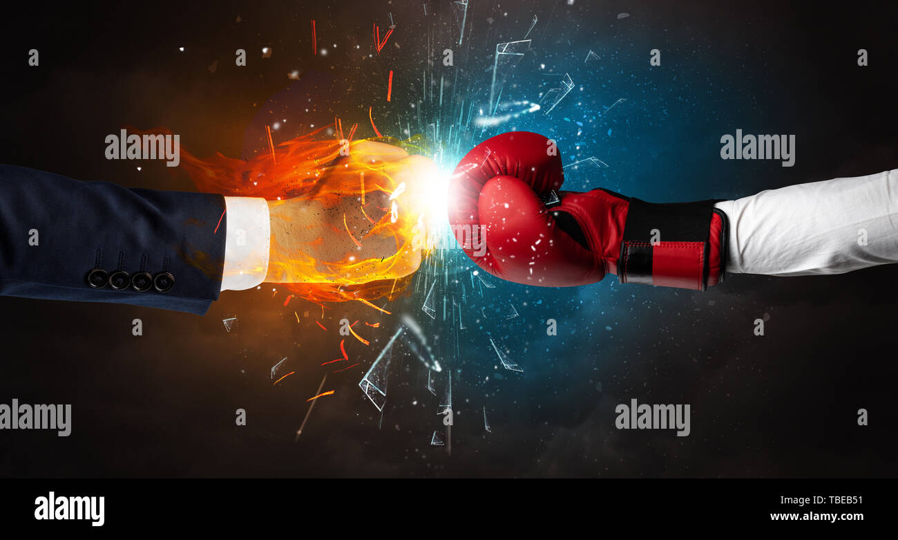 Two hands fighting and breaking glass into small pieces with fire and ...