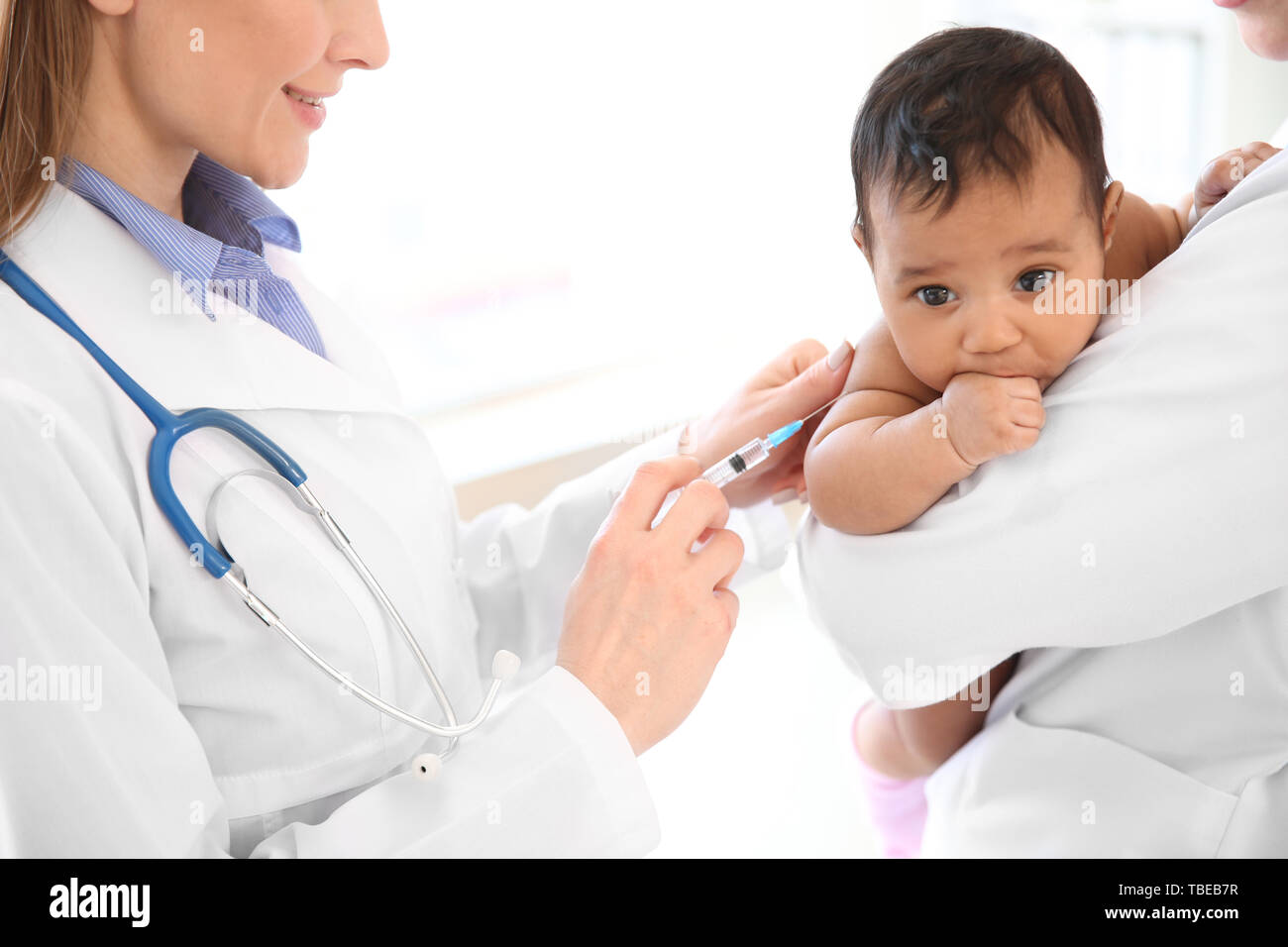 Pediatrician giving little baby an injection in clinic Stock Photo - Alamy