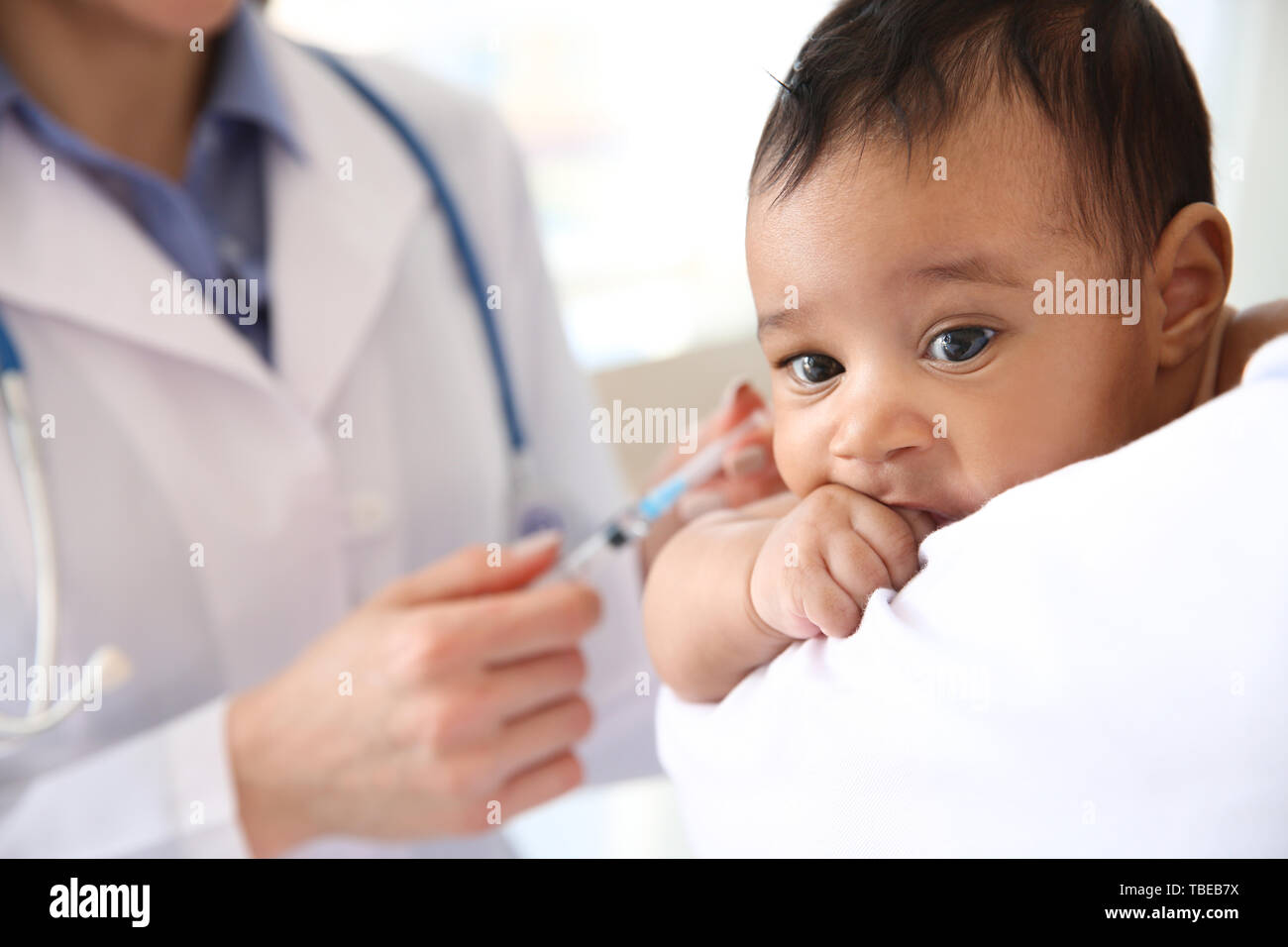 Pediatrician giving little baby an injection in clinic Stock Photo - Alamy