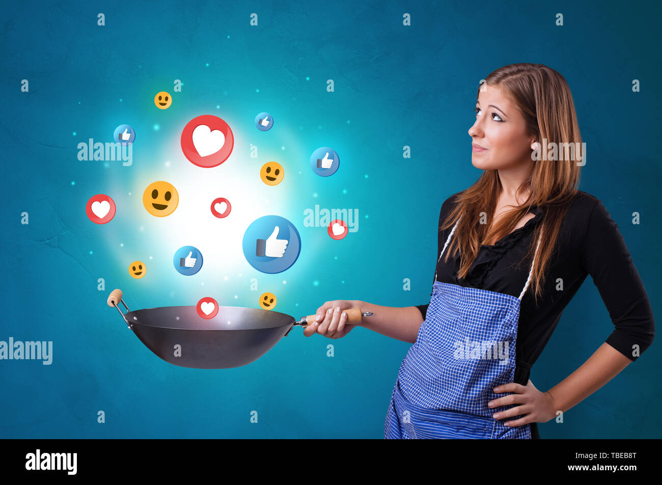 Young happy person cooking social media concept in wok Stock Photo - Alamy