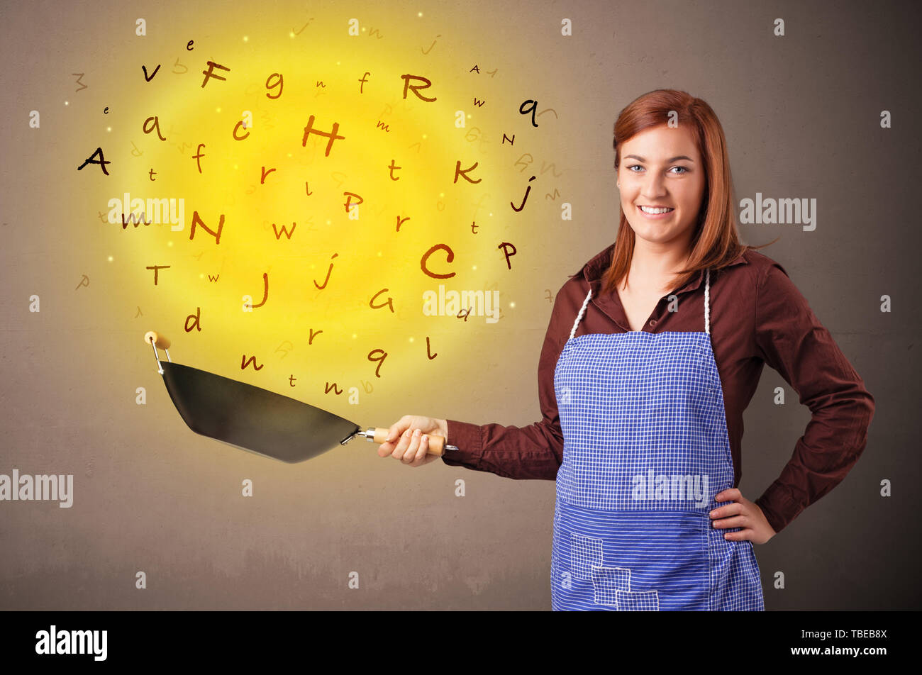 Young person cooking letters in wok Stock Photo - Alamy