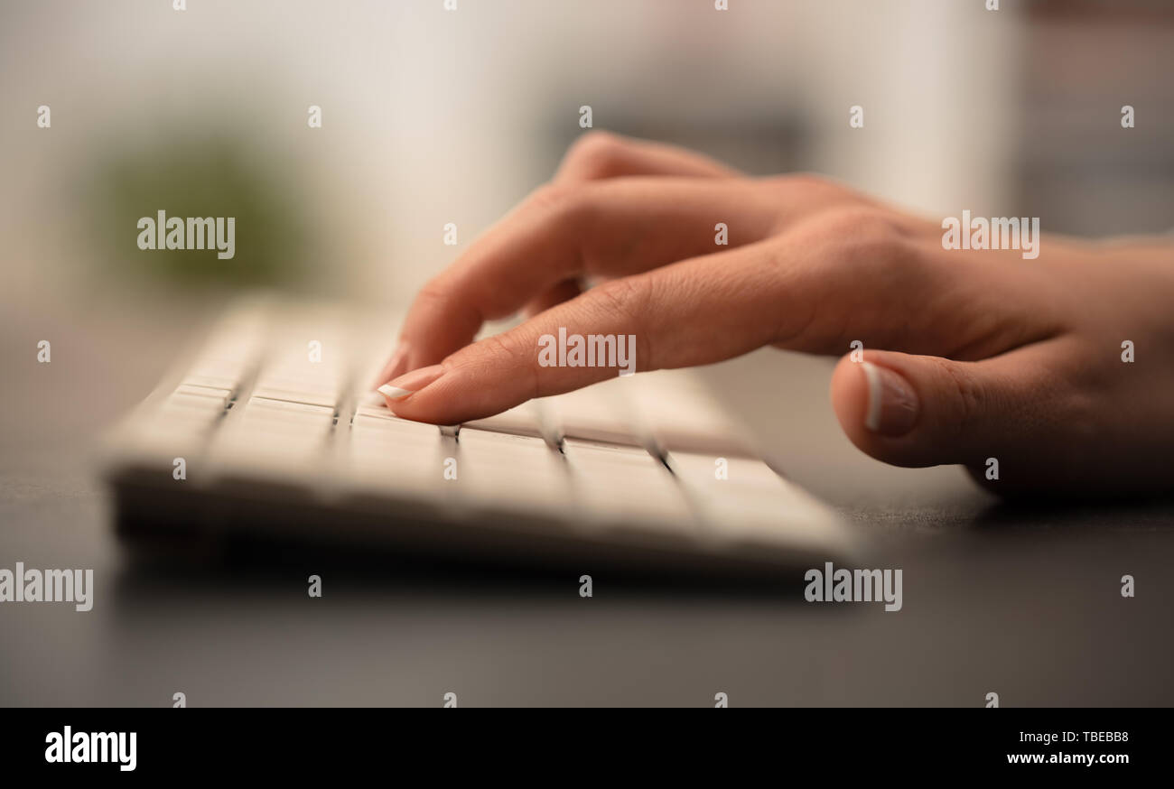 Hand typing on keyboard with office concept Stock Photo - Alamy