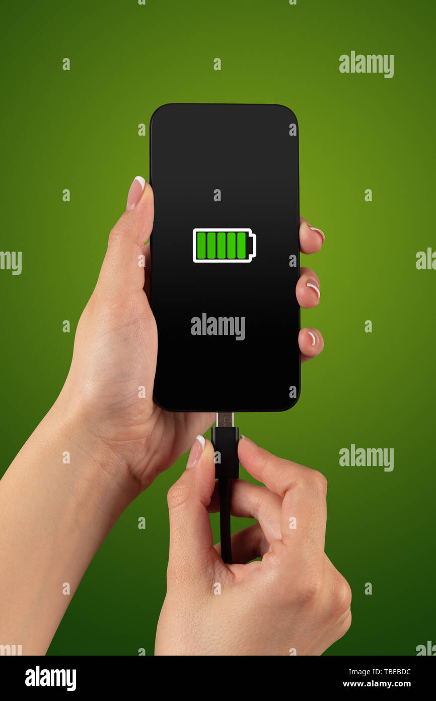Elegant hand charging cellphone with low battery Stock Photo - Alamy