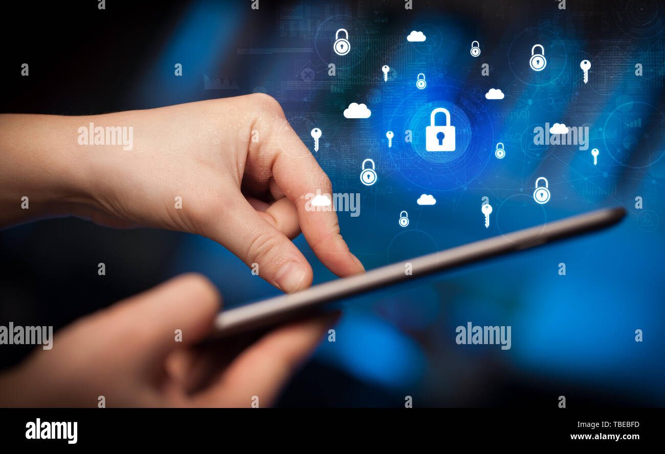 Hand holding tablet with online security system concept Stock Photo - Alamy