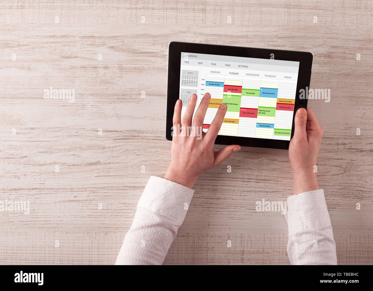 Hand holding tablet with timetable and calendar concept Stock Photo - Alamy