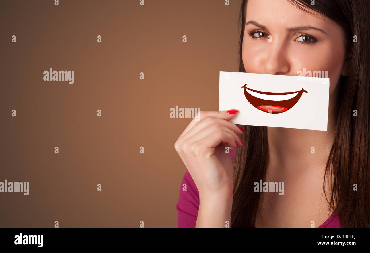 Person holding card in front of his mouth with ironic smile Stock Photo ...