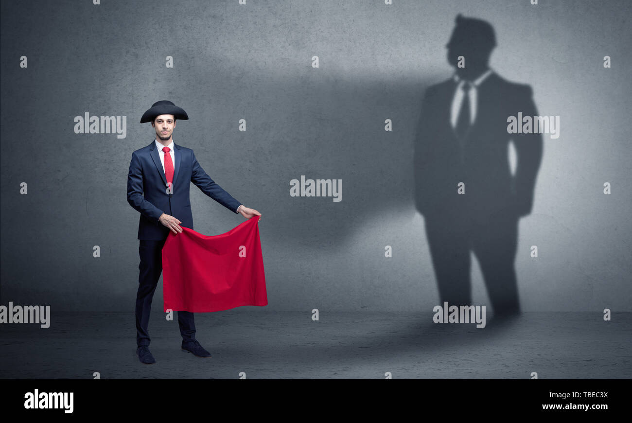 Businessman standing with red cloth on his hand and his shadow on the ...