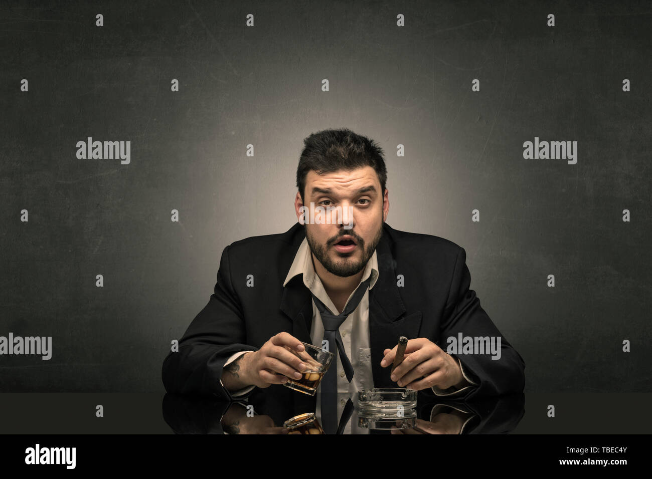 Young drunk man at his office with free dark copyspace Stock Photo - Alamy