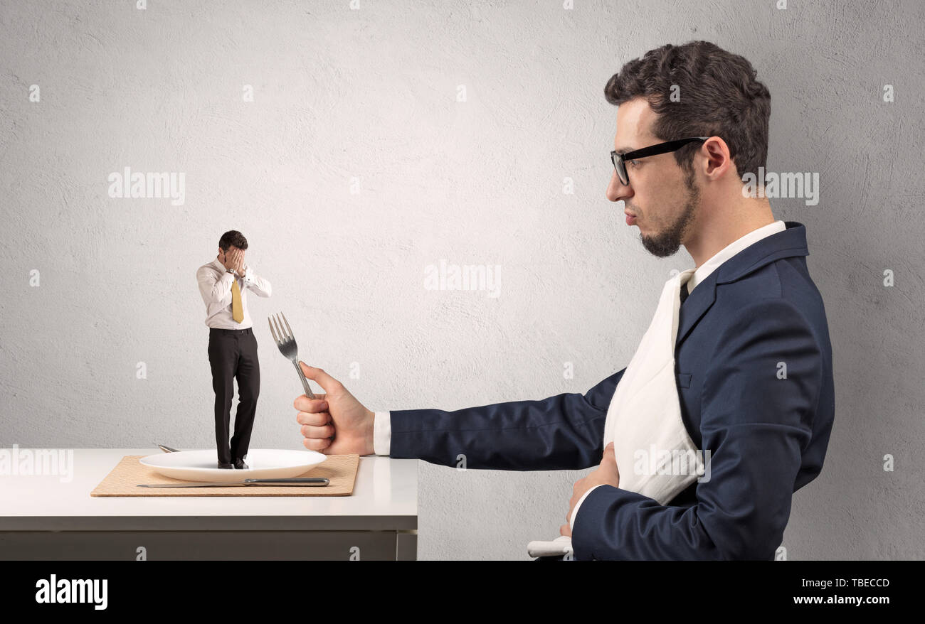Tiny scared weak businessman almost devoured by great power Stock Photo ...