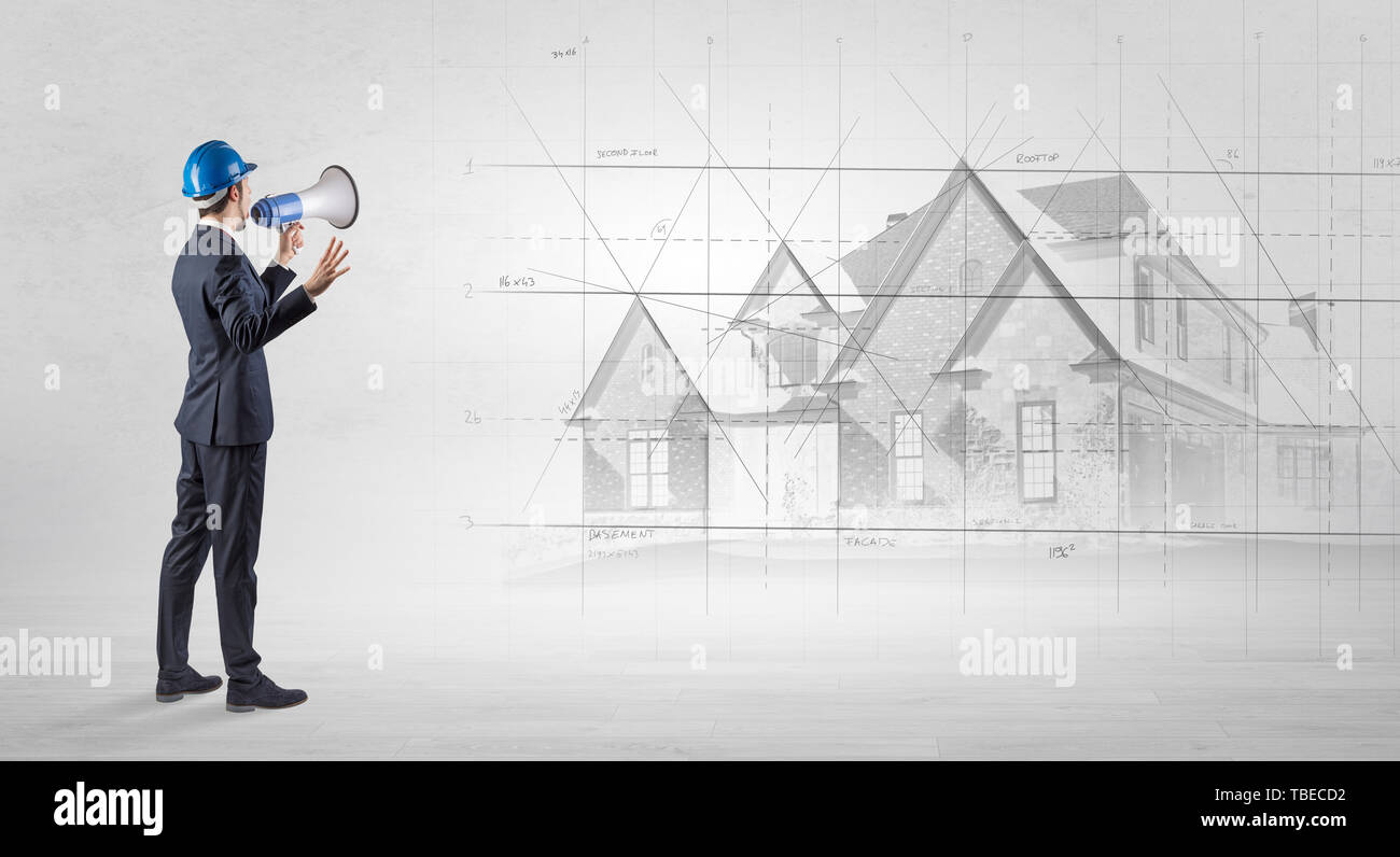 Architect standing and watching an imagined house plan Stock Photo - Alamy