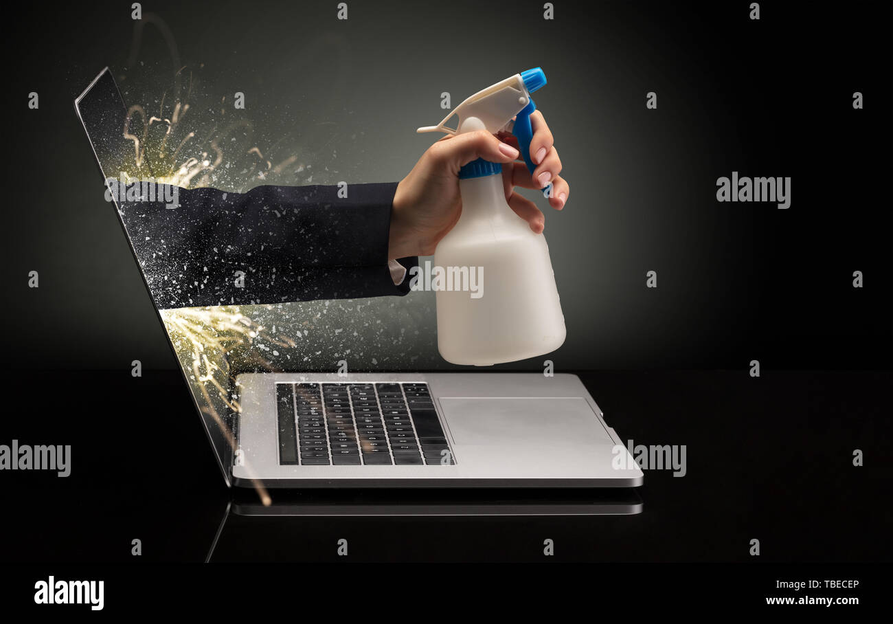 Hand with spray coming out of a laptop with sparkling effects Stock ...