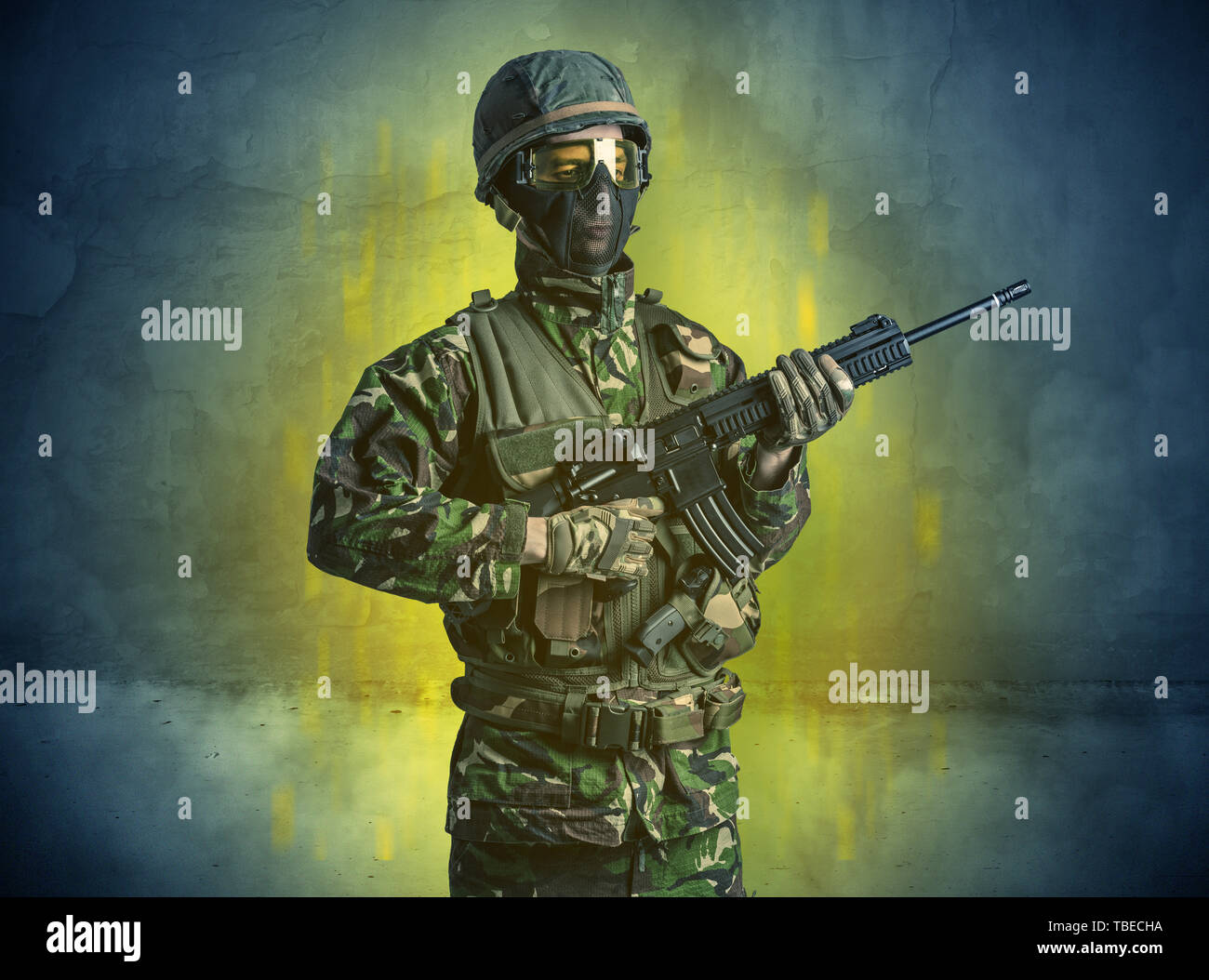 Hazard, menace soldier in a ruined crumbly building with arms on his ...