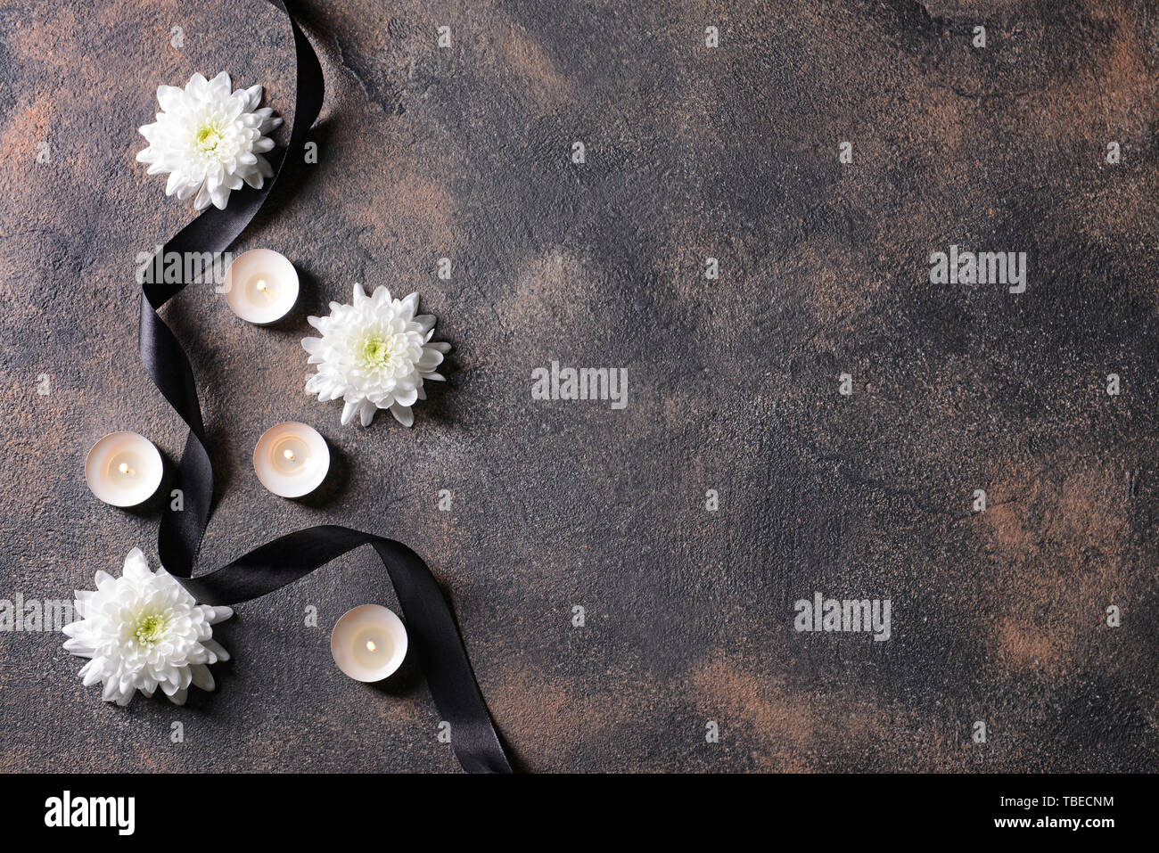 Black mourning ribbon, flowers and candles on grunge background Stock ...