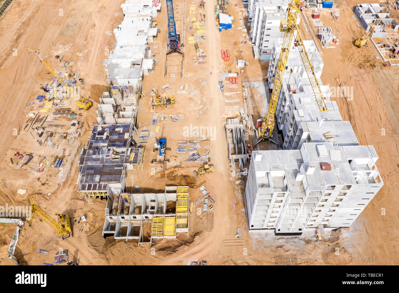 aerial top view of city construction site. industrial tower cranes ...
