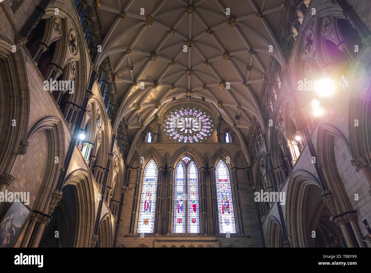 The sun reflects a colorful silhouette through the rose window of York ...
