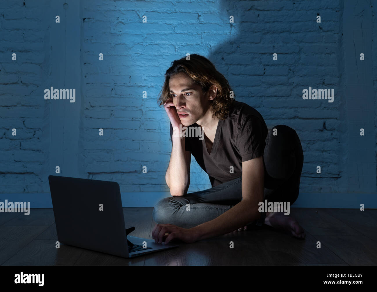 Severely distraught young teen man with laptop suffering cyberbullying ...