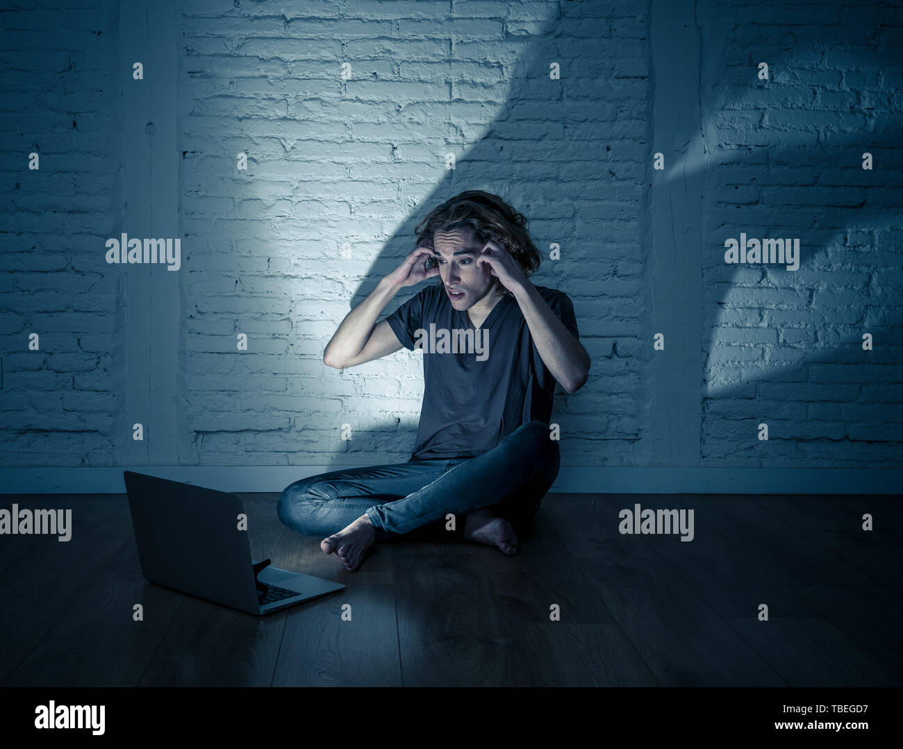 Severely distraught young teen man with laptop suffering cyberbullying ...
