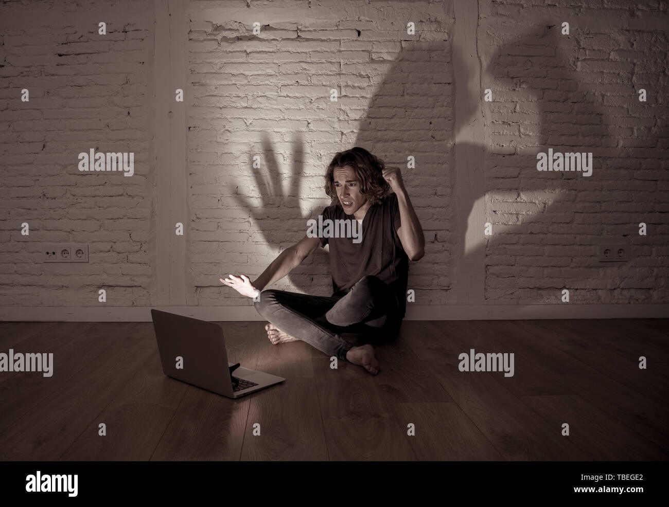 Severely distraught young teen man with laptop suffering cyberbullying ...