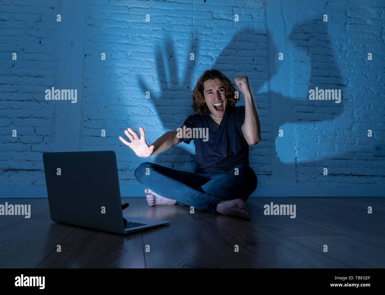 Severely distraught young teen man with laptop suffering cyberbullying ...