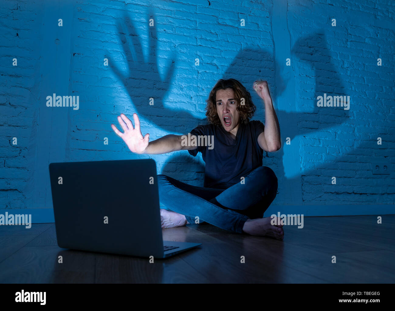 Severely distraught young teen man with laptop suffering cyberbullying ...