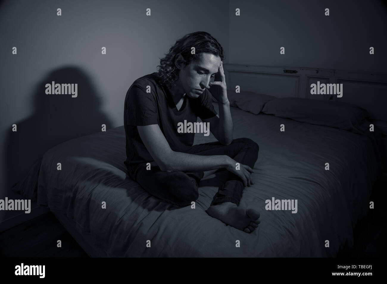 Devastated millennial man crying sad feeling hurt and hopeless ...