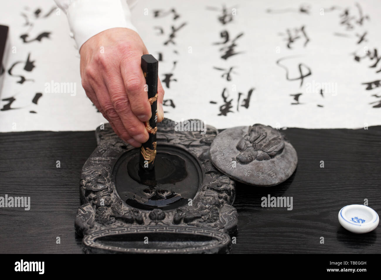 An old man practicing calligraphy Stock Photo - Alamy