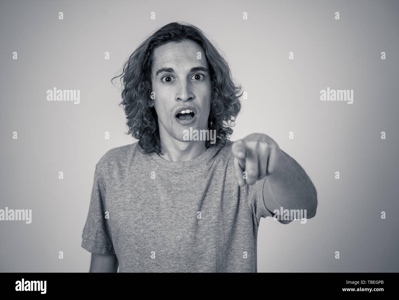 Portrait of Amazed excited funny millennial man pointing at something ...