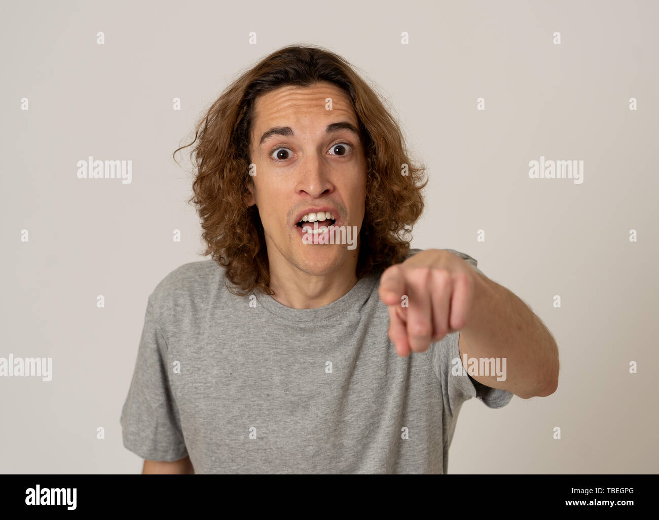 Portrait of Amazed excited funny millennial man pointing at something ...