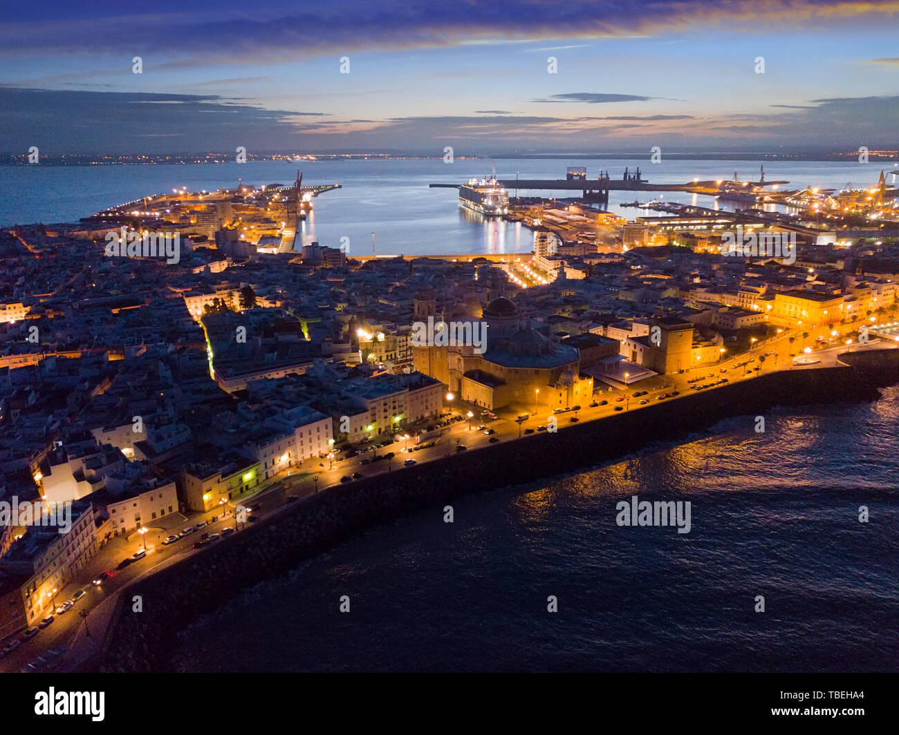 Panoramic view of illuminated Cadiz port city with medieval Cathedral ...