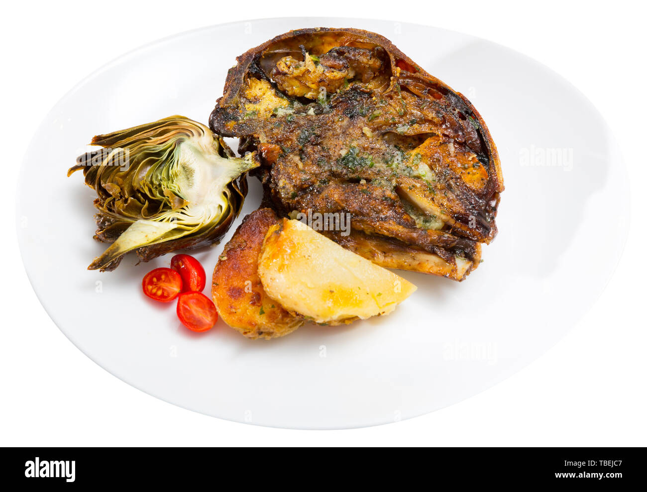Delicious baked head of lamb served on white plate with roasted ...