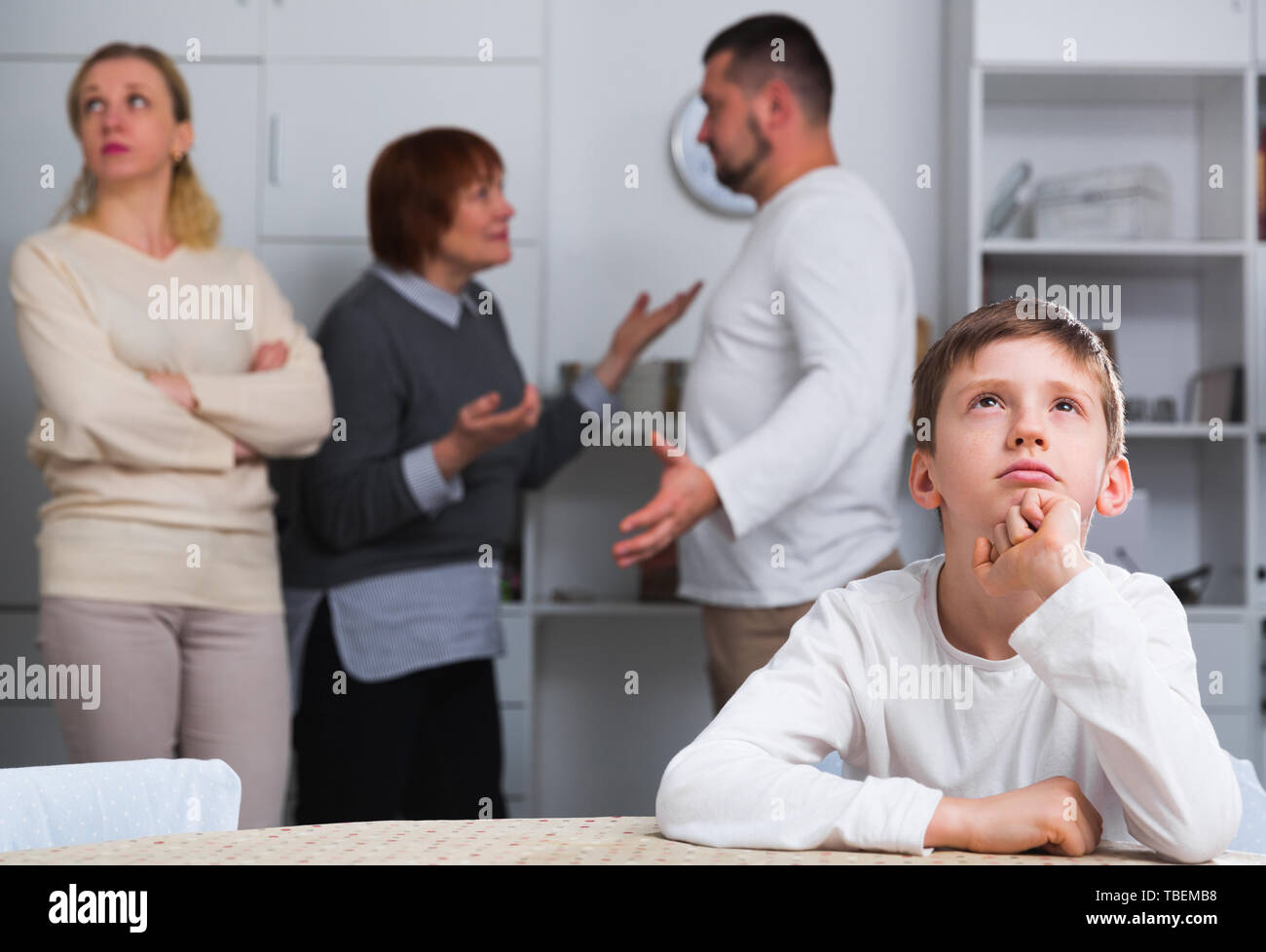 Sad desperate little boy during parents quarrel in home interior Stock ...