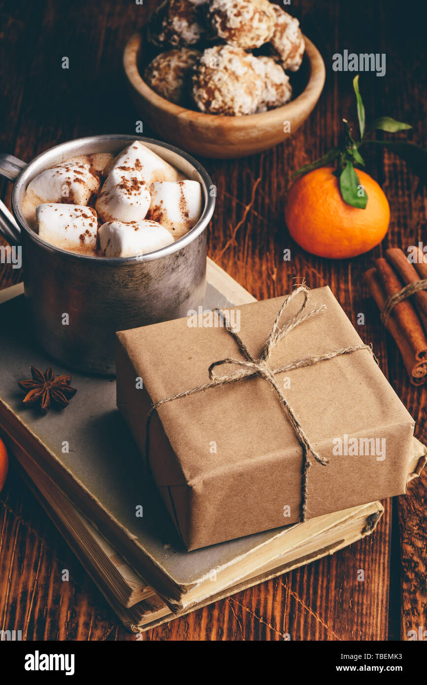 Gift box packed with craft paper on stack of old books Stock Photo - Alamy
