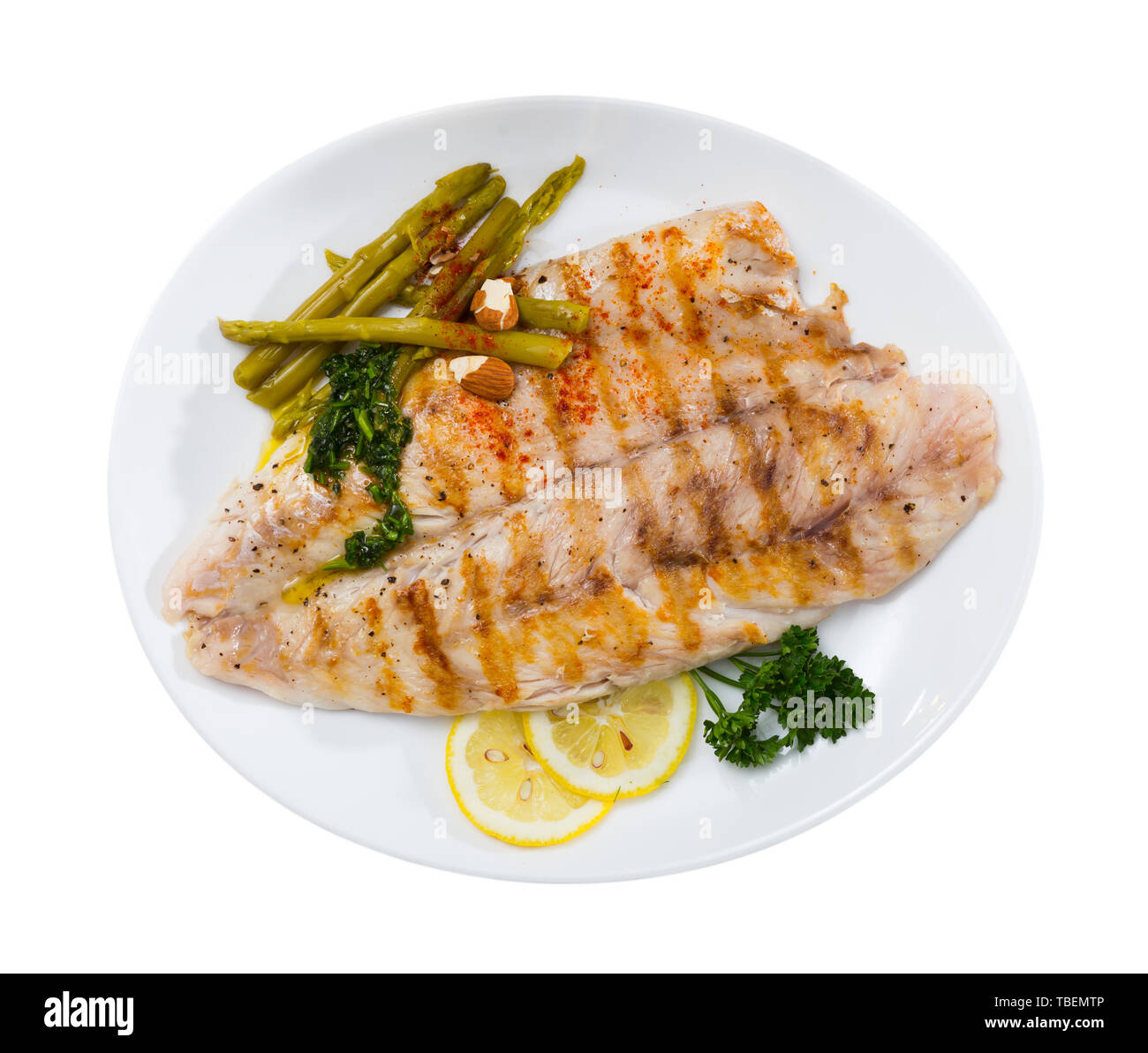 Baked perch fillet served with herbal sauce, marinated asparagus and ...