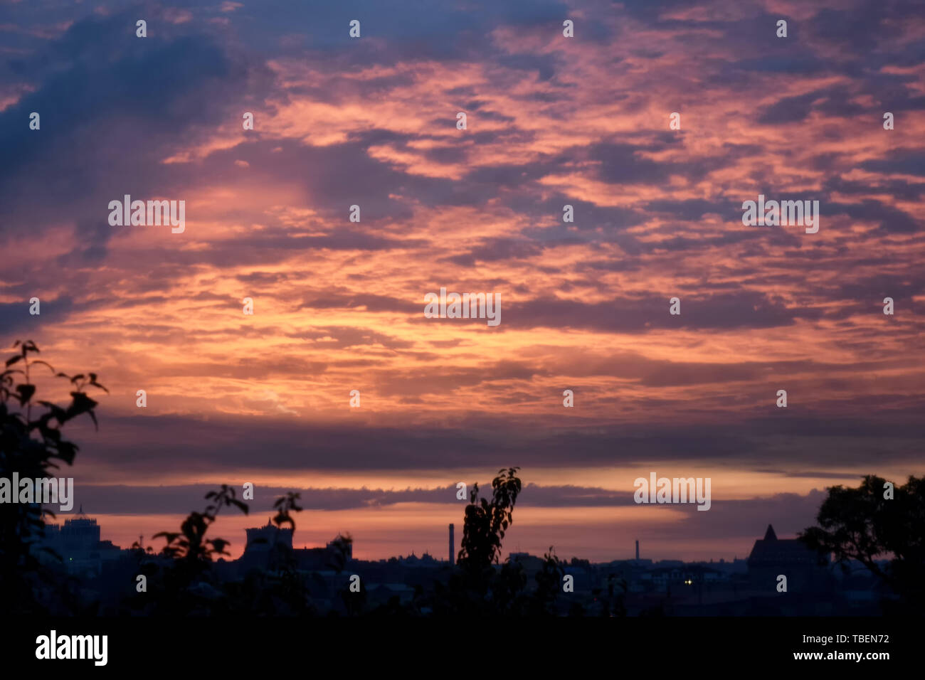sunset over city, round red sun and the night sky Stock Photo - Alamy